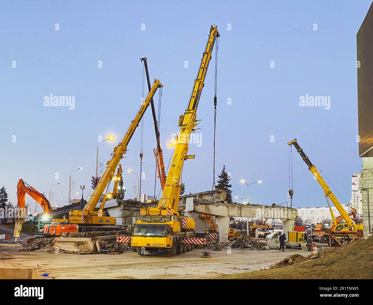 construction of a broken bridge on a busy road. construction equipment ...