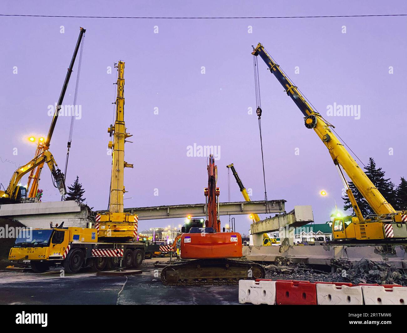 construction of a broken bridge on a busy road. construction equipment ...