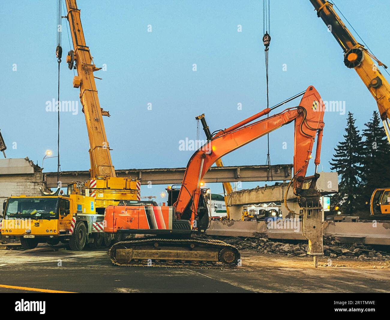 construction of a broken bridge on a busy road. the chipper makes a ...