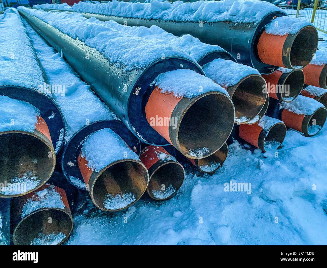 long, black, narrow pipes for laying plumbing communications. metal ...