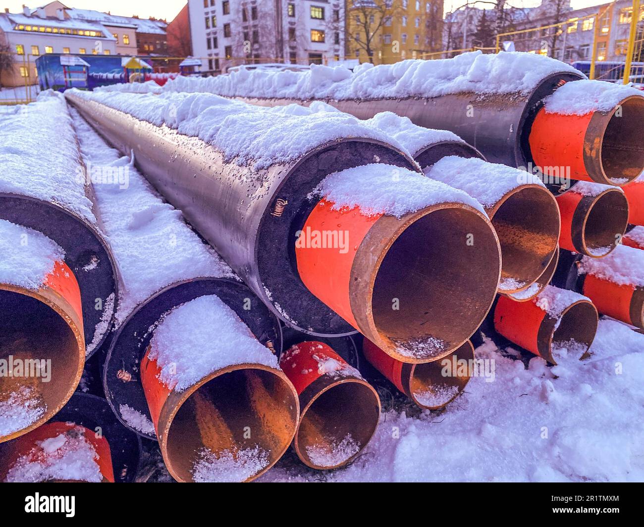 long, black, narrow pipes for laying plumbing communications. metal ...