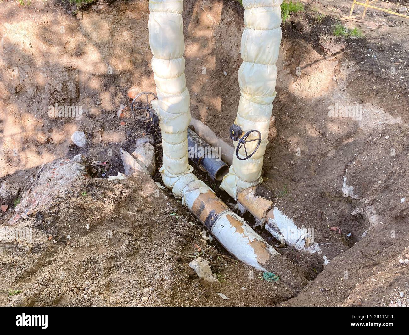 laying of underground communications for residential buildings. plumbing pipes in black with a ...