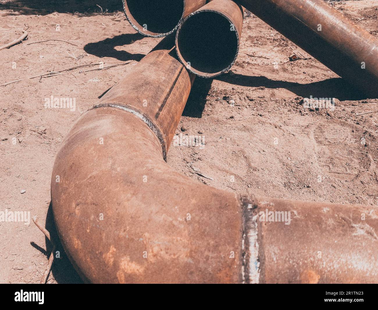 metal pipe lies on the ground. laying communications for residential ...