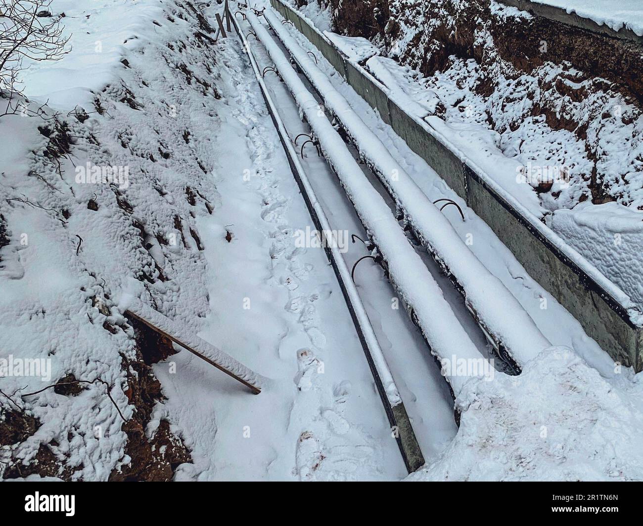 long, thin, black, narrow pipes for laying plumbing communications ...