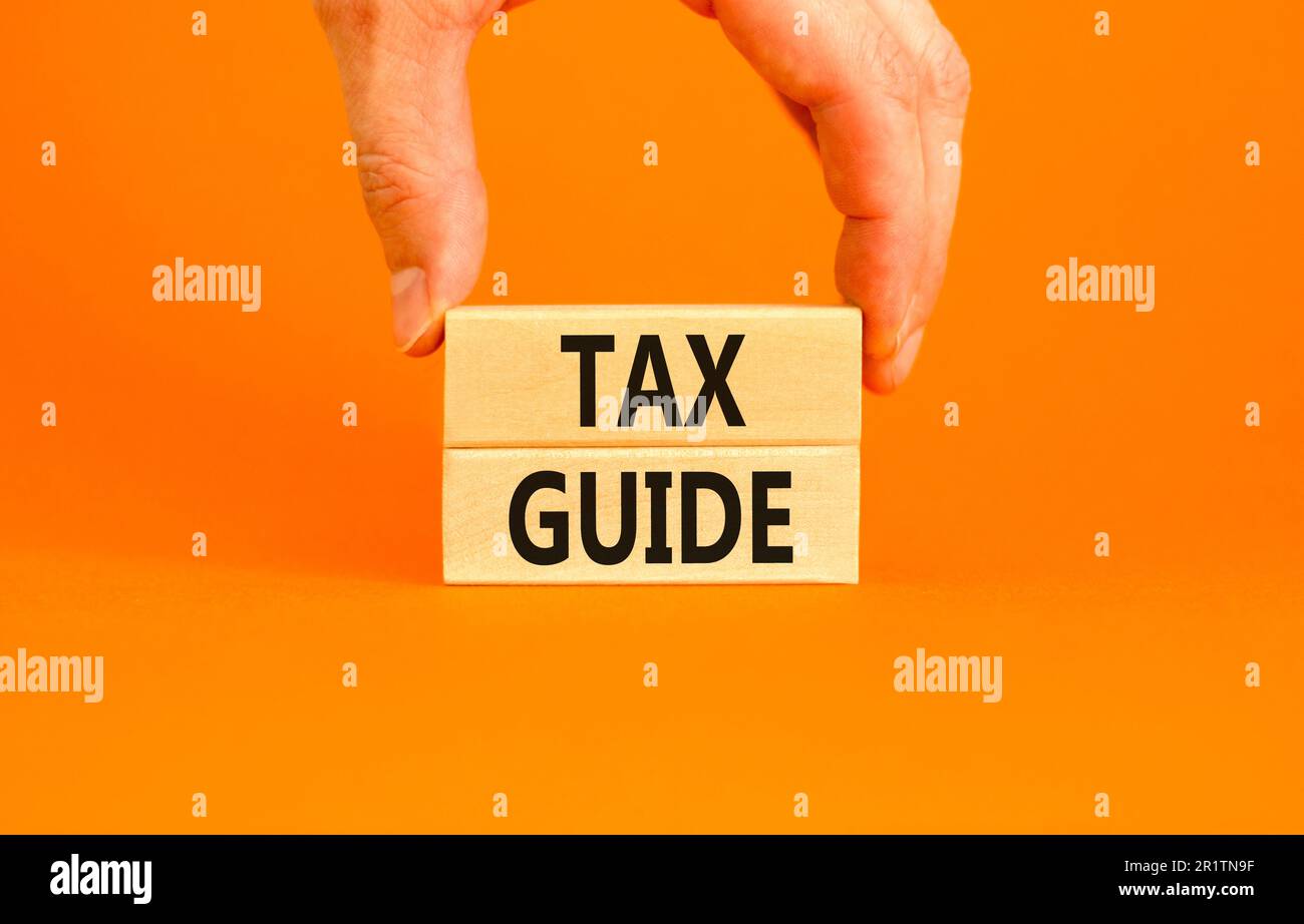 Tax guide symbol. Concept words Tax guide on beautiful wooden block ...