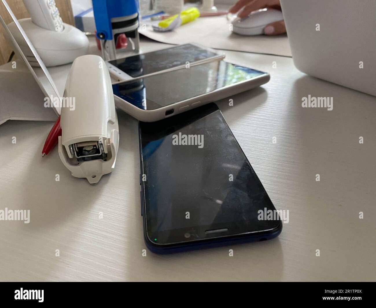 Two working touchscreen mobile phones, smartphones lie on the table in ...