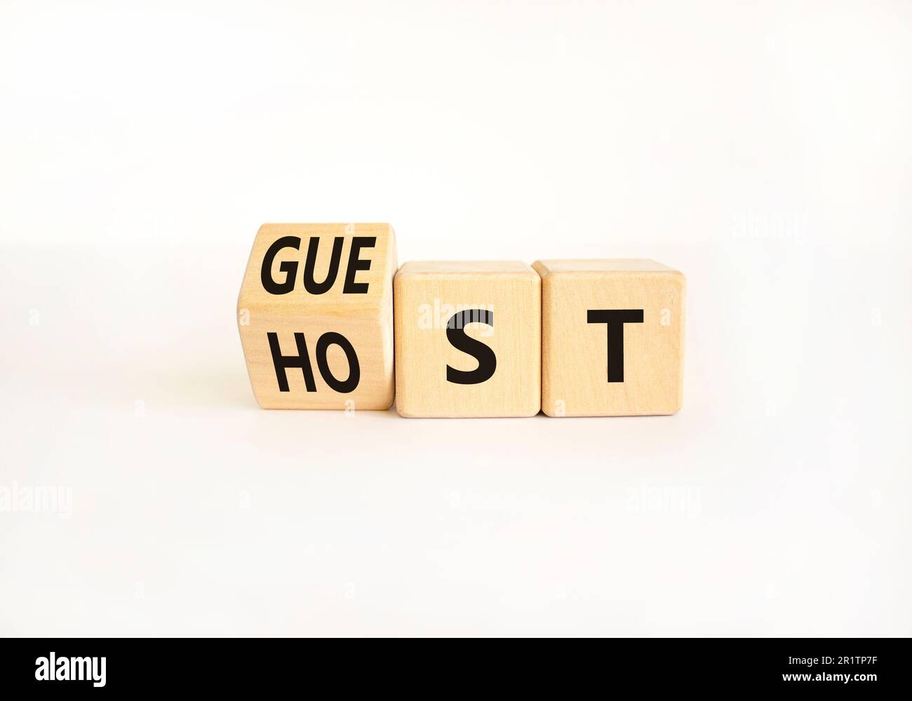 Guest and host symbol. Businessman turns wooden cubes and changes the ...