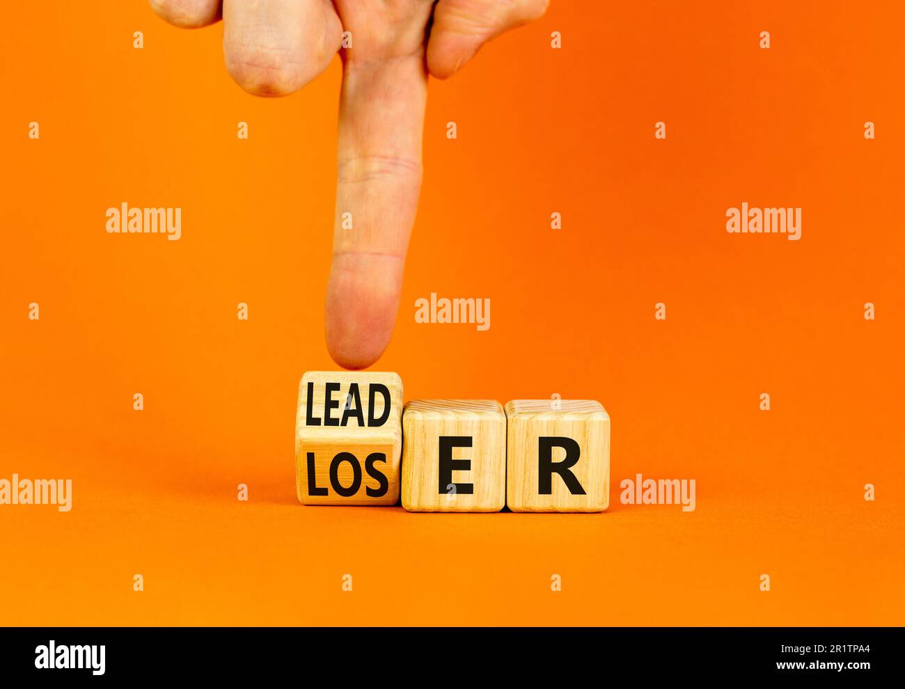 Loser or leader symbol. Businessman turns wooden cubes and changes the ...