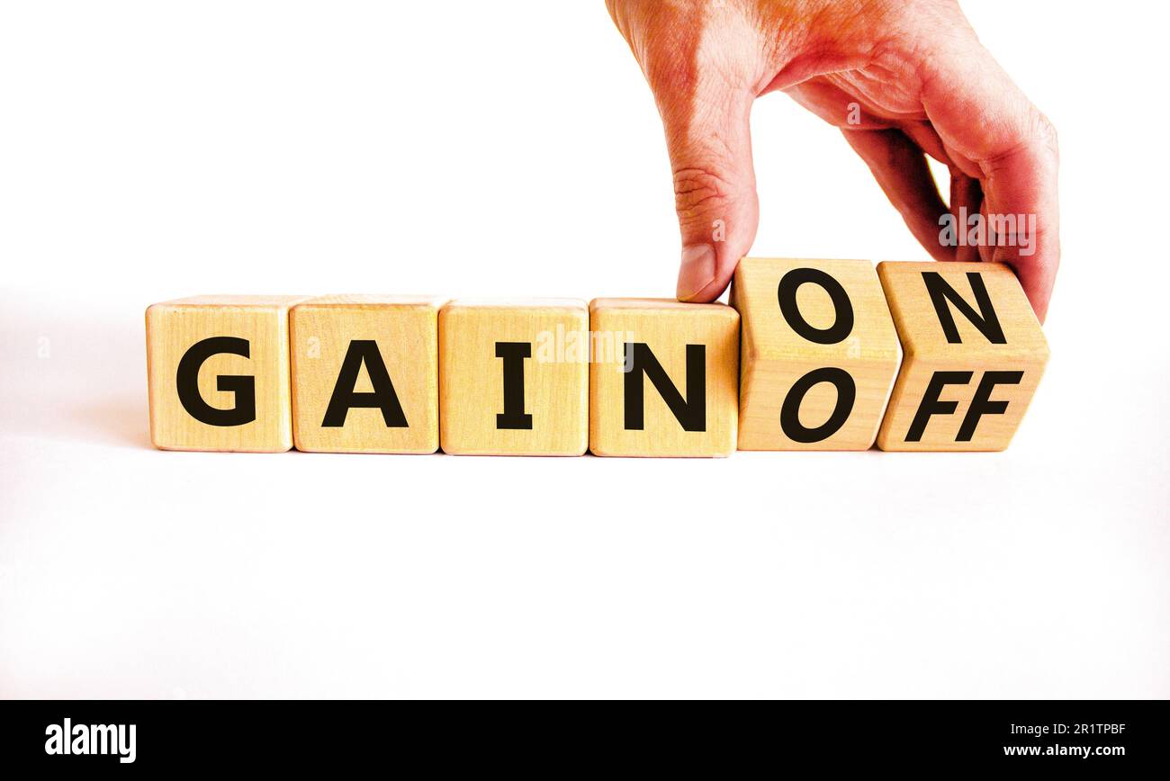 Gain on or off symbol. Businessman turns wooden cubes and changes word ...