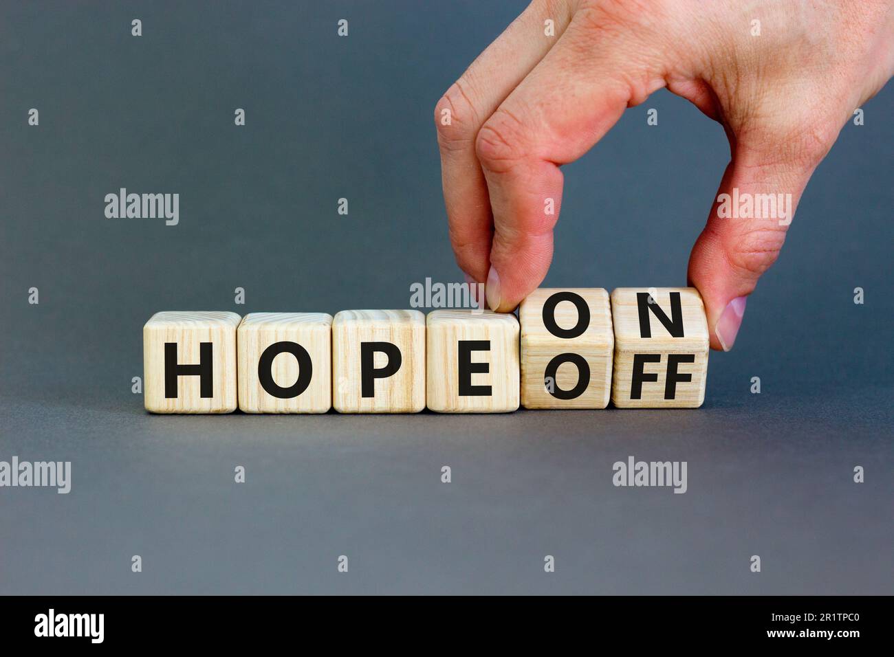 Hope on or off symbol. Businessman turns wooden cubes and changes word ...