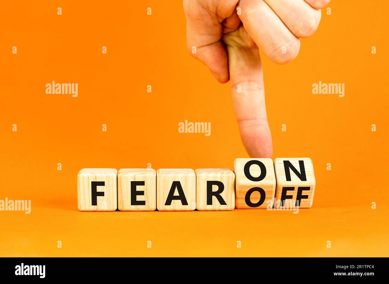 Fear on or off symbol. Businessman turns wooden cubes and changes word ...