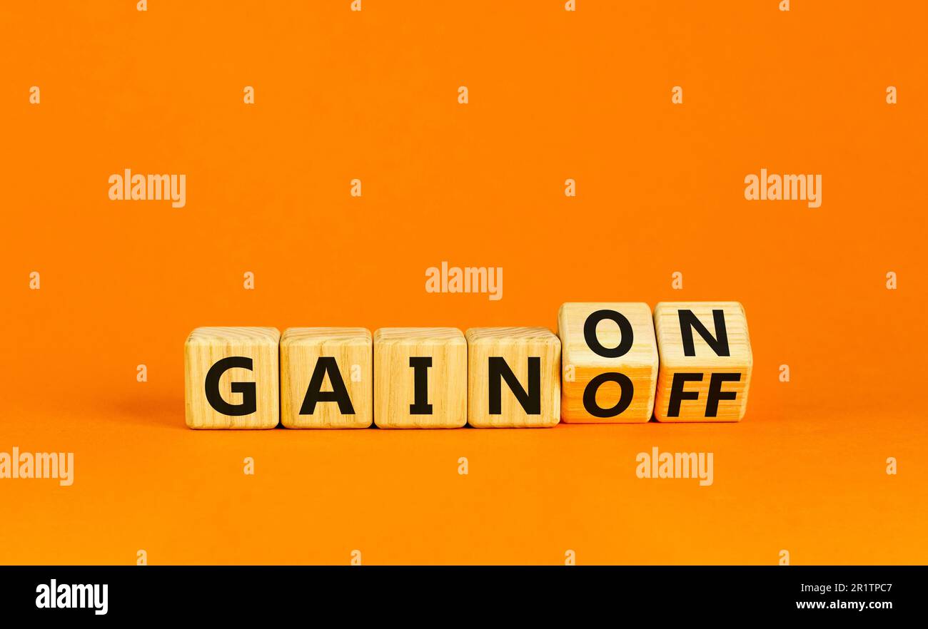 Gain on or off symbol. Businessman turns wooden cubes and changes word ...