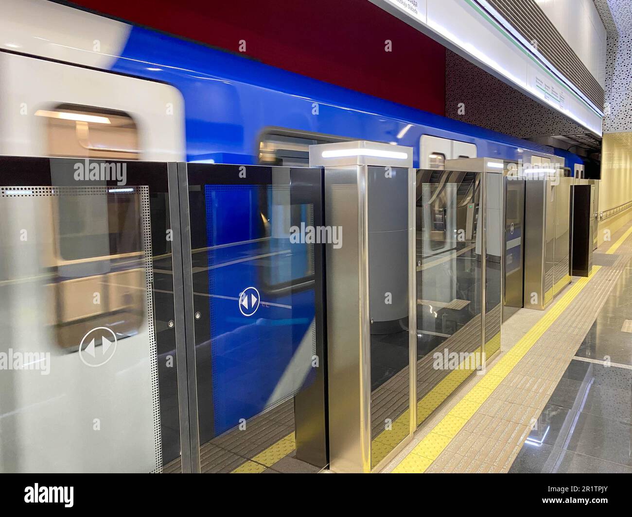 A blue train carriage with open and closed sliding mechanical door and ...
