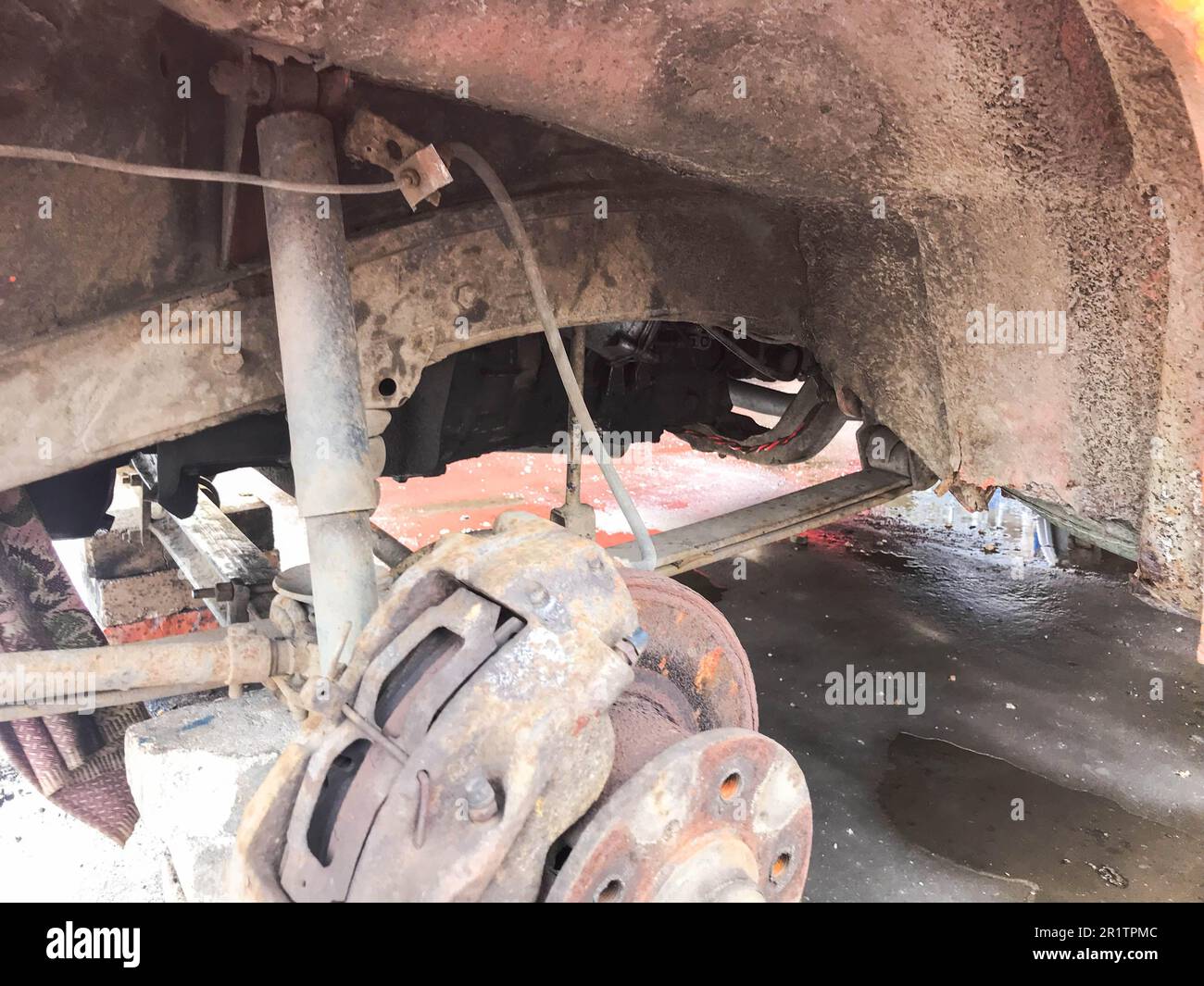 Old rusty worn brake discs, pads of a truck, car. Car suspension repair ...