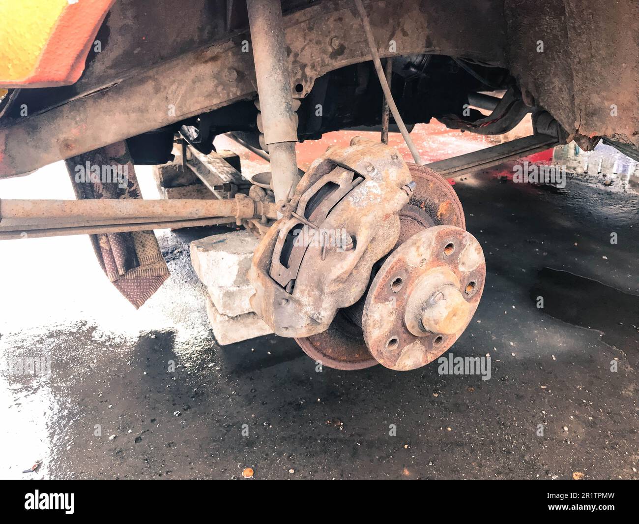 Old rusty worn brake discs, pads of a truck, car. Car suspension repair ...