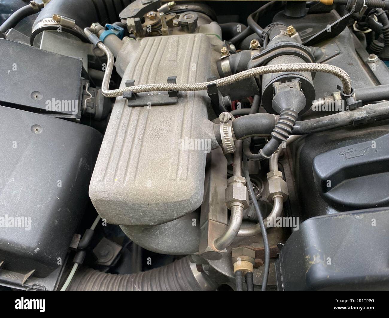 Engine compartment under car hood with emphasis on oil dipstick ...