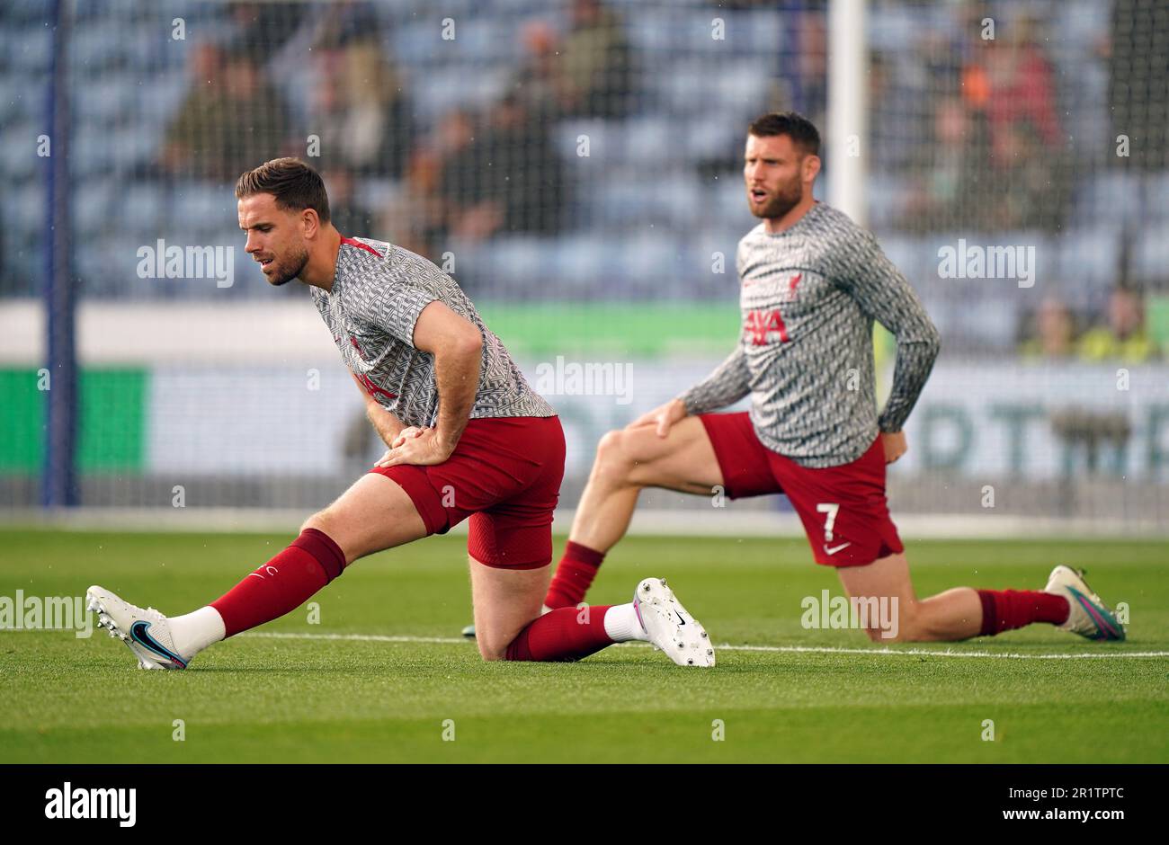Liverpool's Jordan Henderson and James Milner (right) warm up on the ...