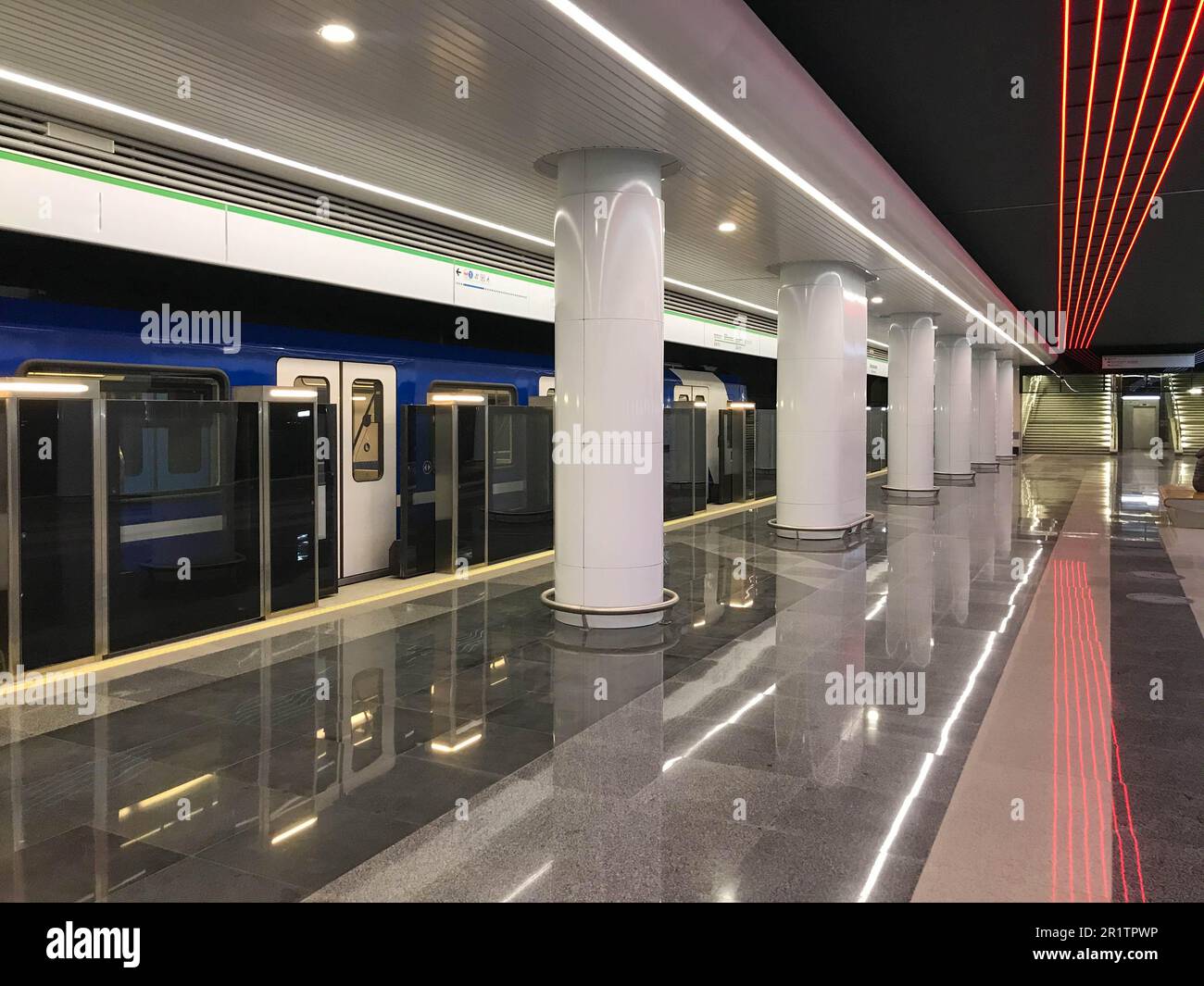 Nearly empty urban metro station with departing train Stock Photo - Alamy