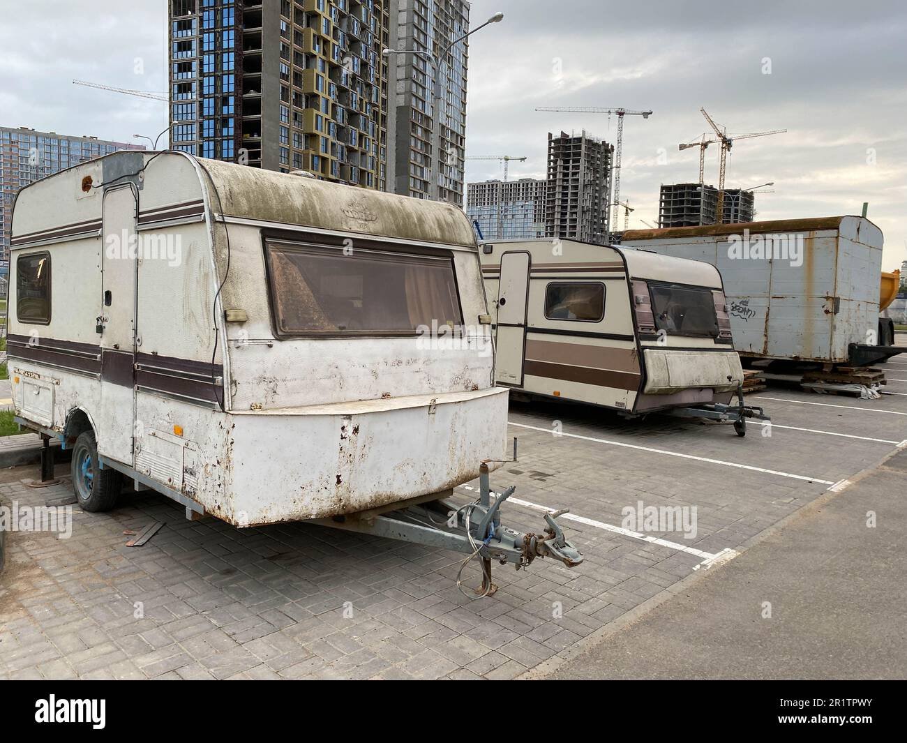 Old white rusty caravan trailers, mobile homes are parked Stock Photo ...