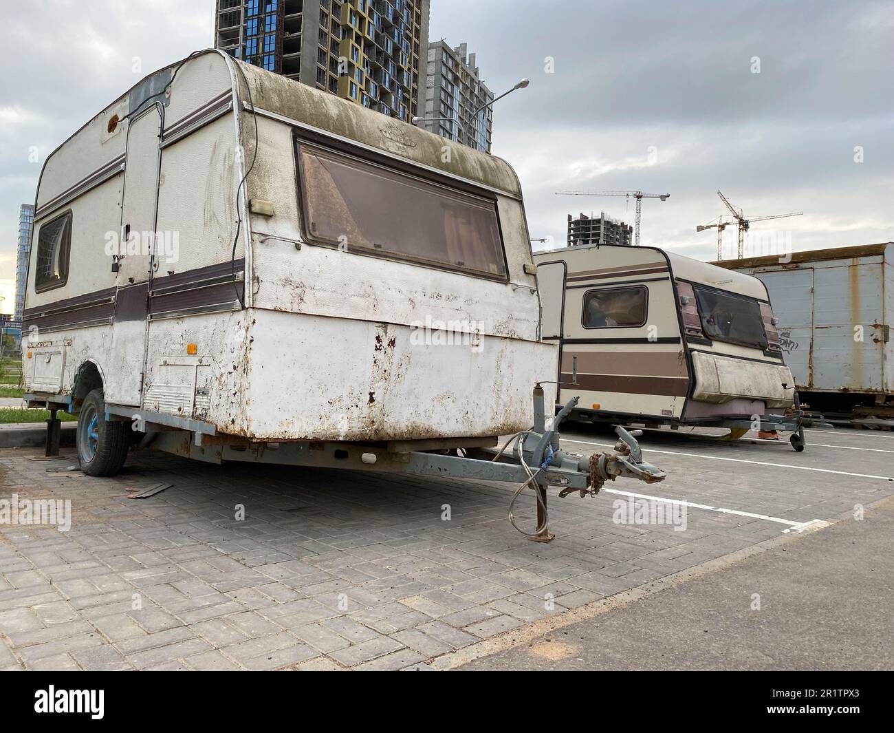 Old white rusty caravan trailers, mobile homes are parked Stock Photo ...