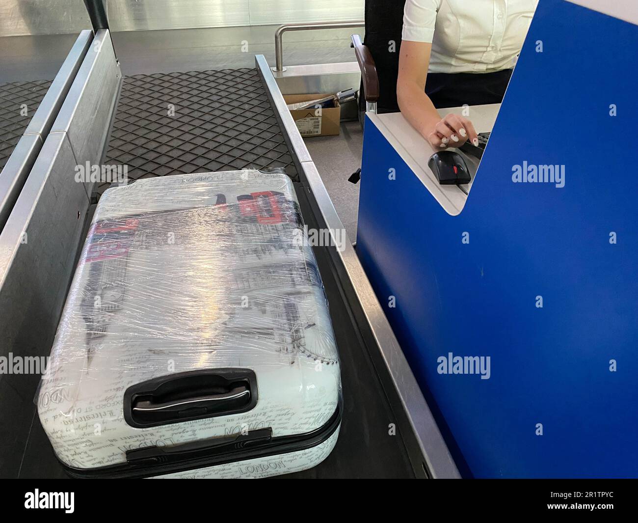 Suitcases travel on a conveyor belt at the airport. Baggage unloaded at ...