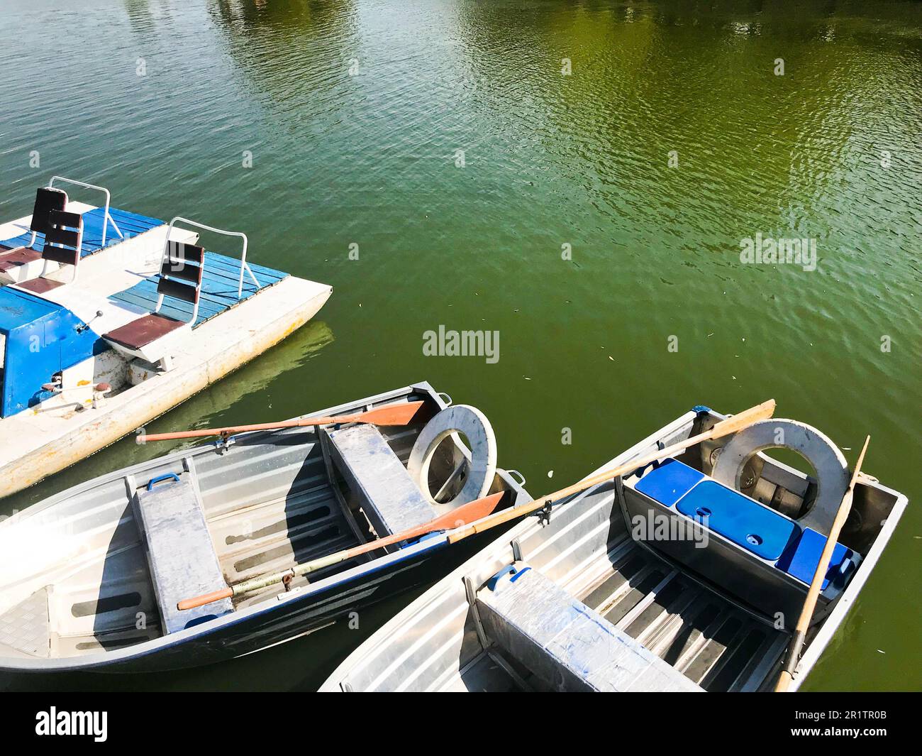 Boats and catamarans on a pond lake in a river canal with green ...
