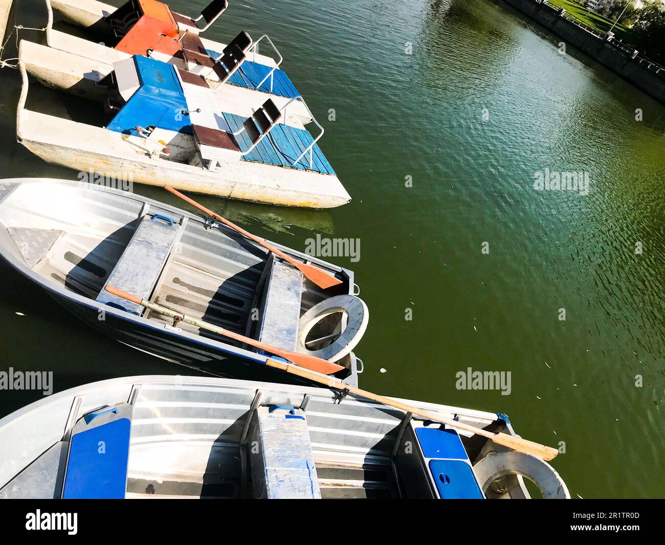 Boats and catamarans on a pond lake in a river canal with green ...