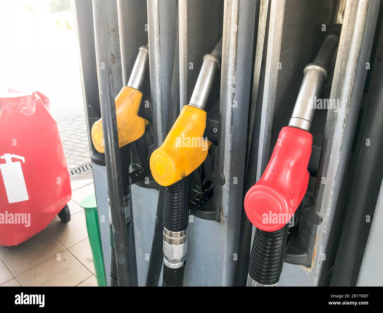 Filling colorful guns at a gas station for refueling a car with fuel ...