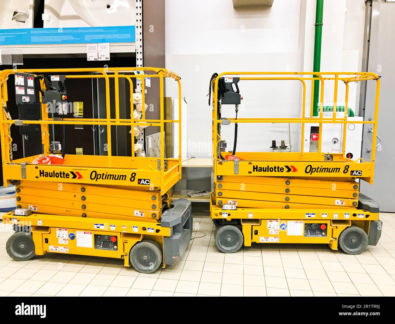 Large yellow mobile hydraulic lift on wheels for lifting and moving ...