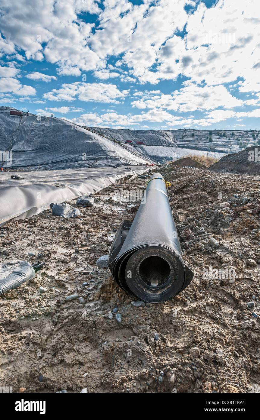 A roll of geomembrane plastic sheeting at an active landfill Stock ...