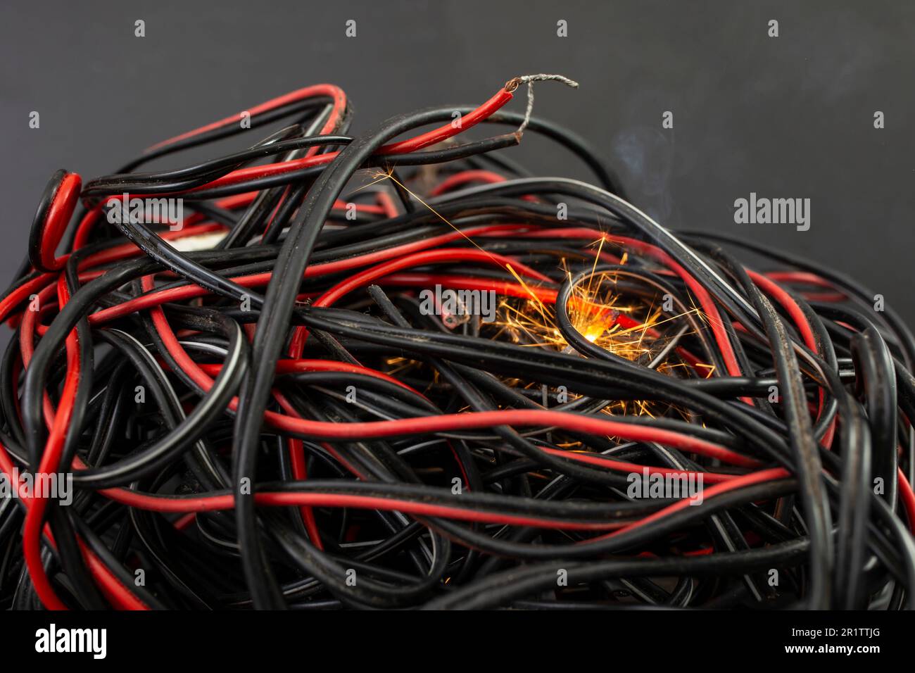 Smoke and sparks on many electrical cables, fire hazard concept, soft ...