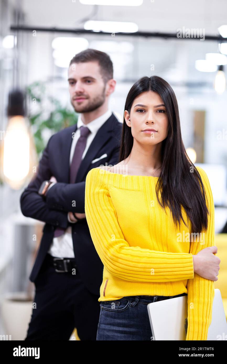 Beautiful Caucasian dark haired girl in yellow posing with businessman ...
