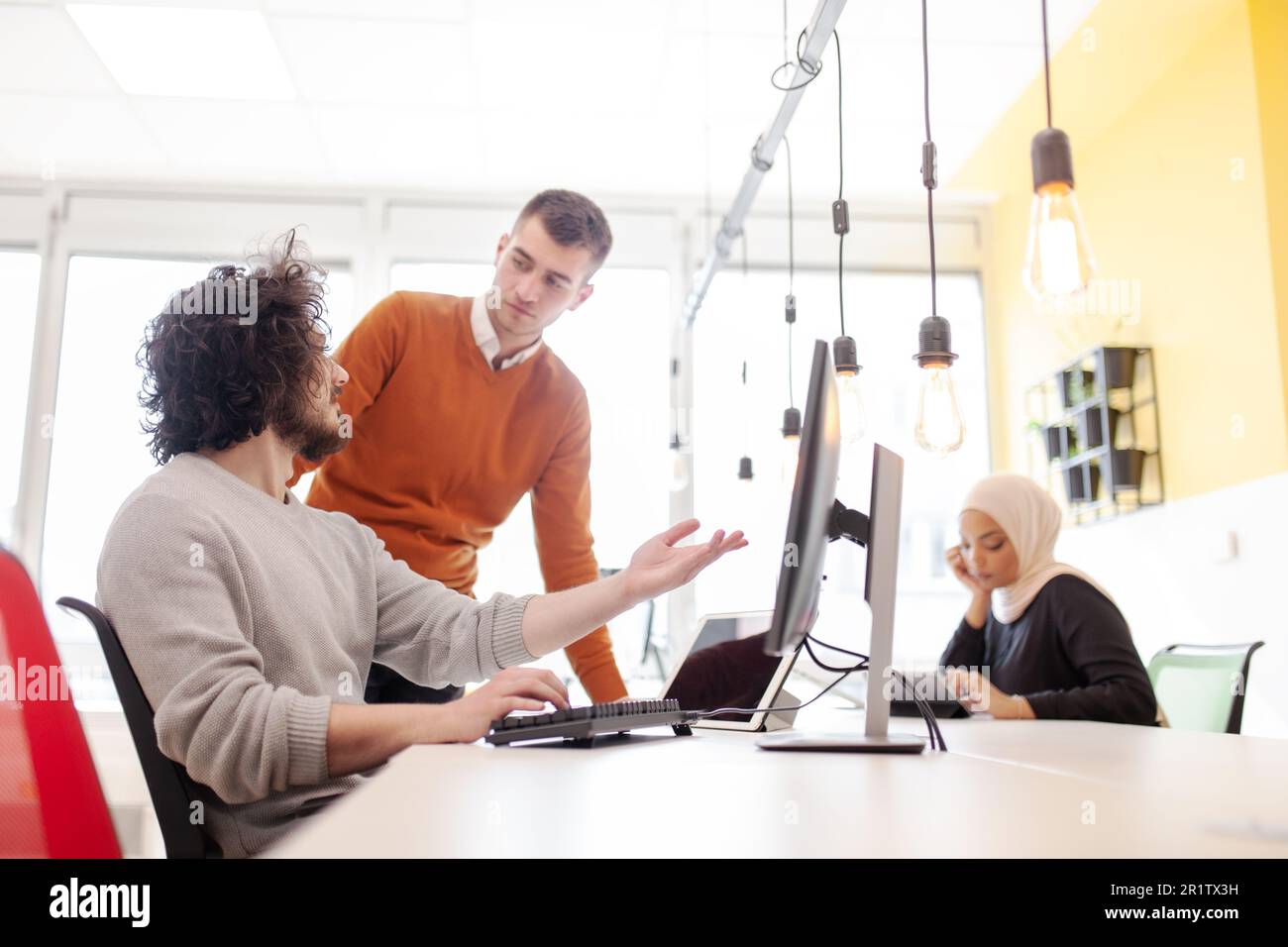 Business people having conversation in front of a computer. Modern ...