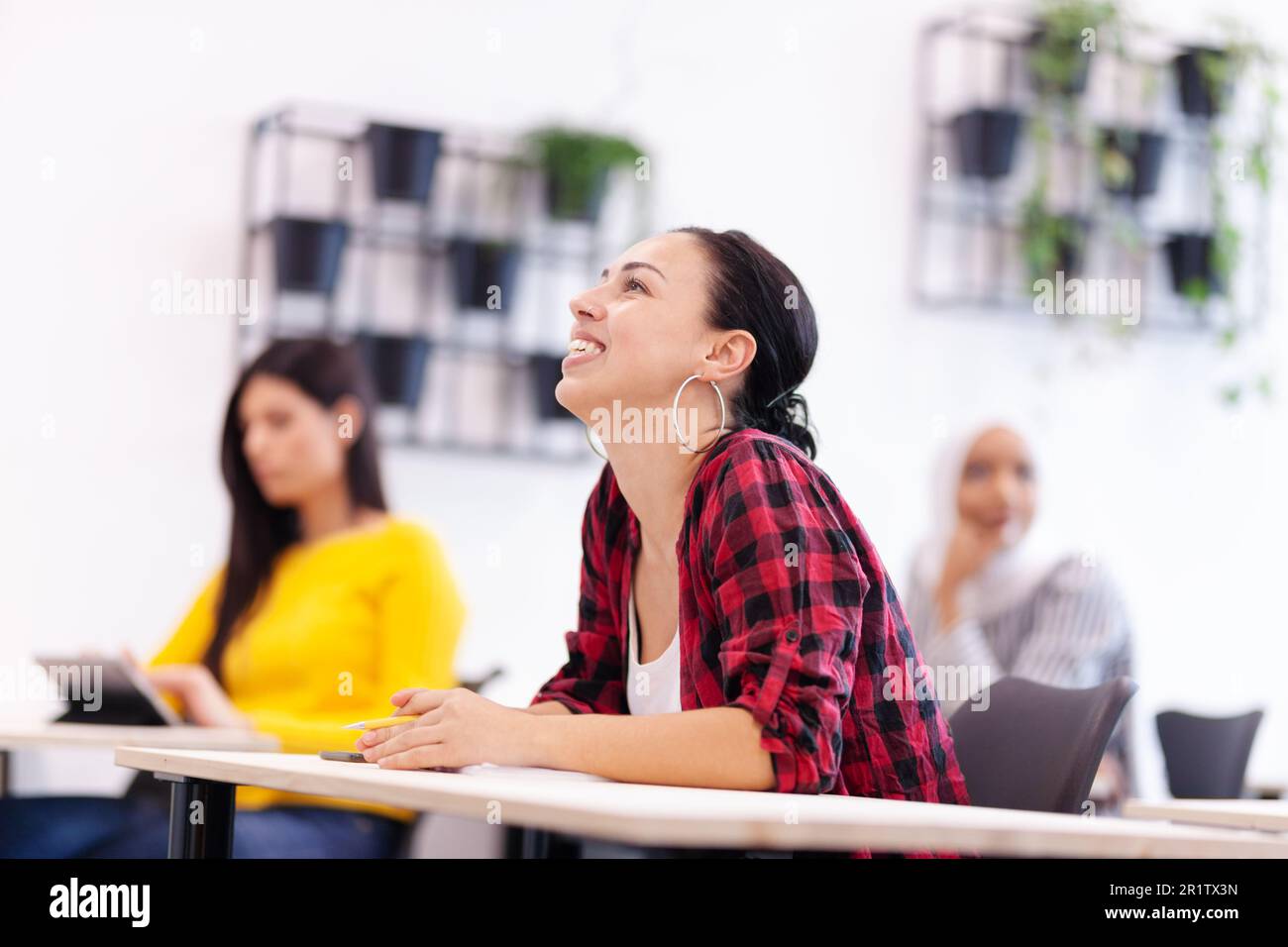 Multi ethnic students listening to a lecturer in a classroom. Smart ...