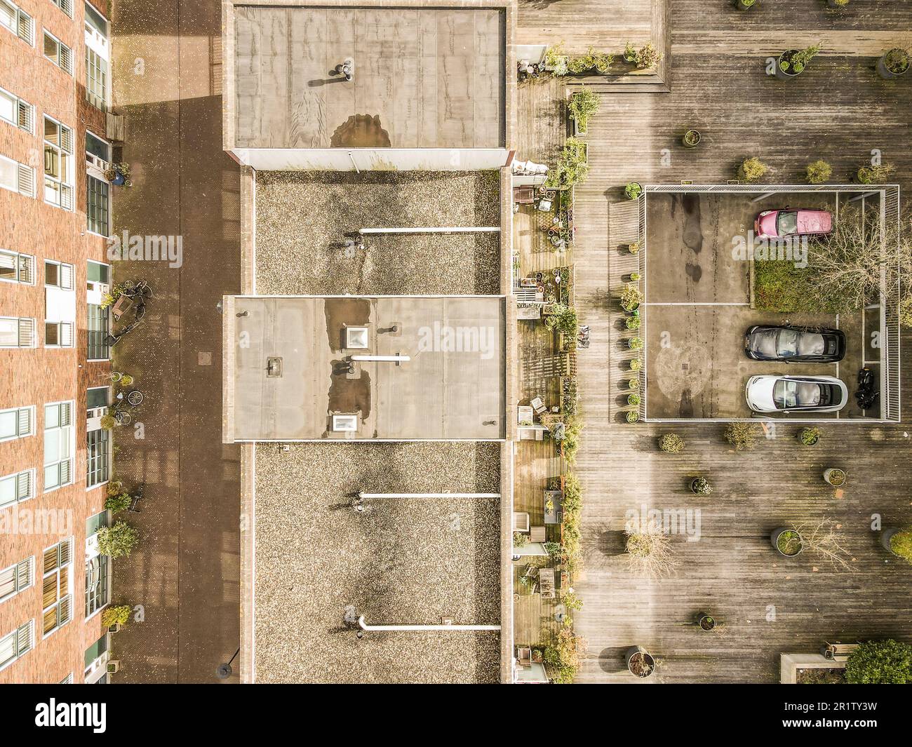 a parking lot with cars parked on the side and buildings in the back ...