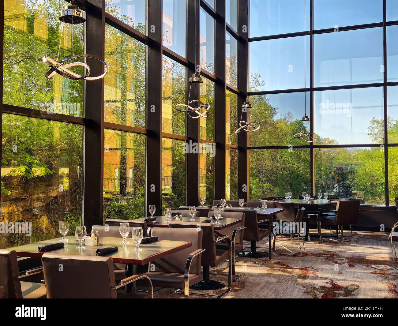 Restaurant interior with glass windows and hanging contemporary lights ...