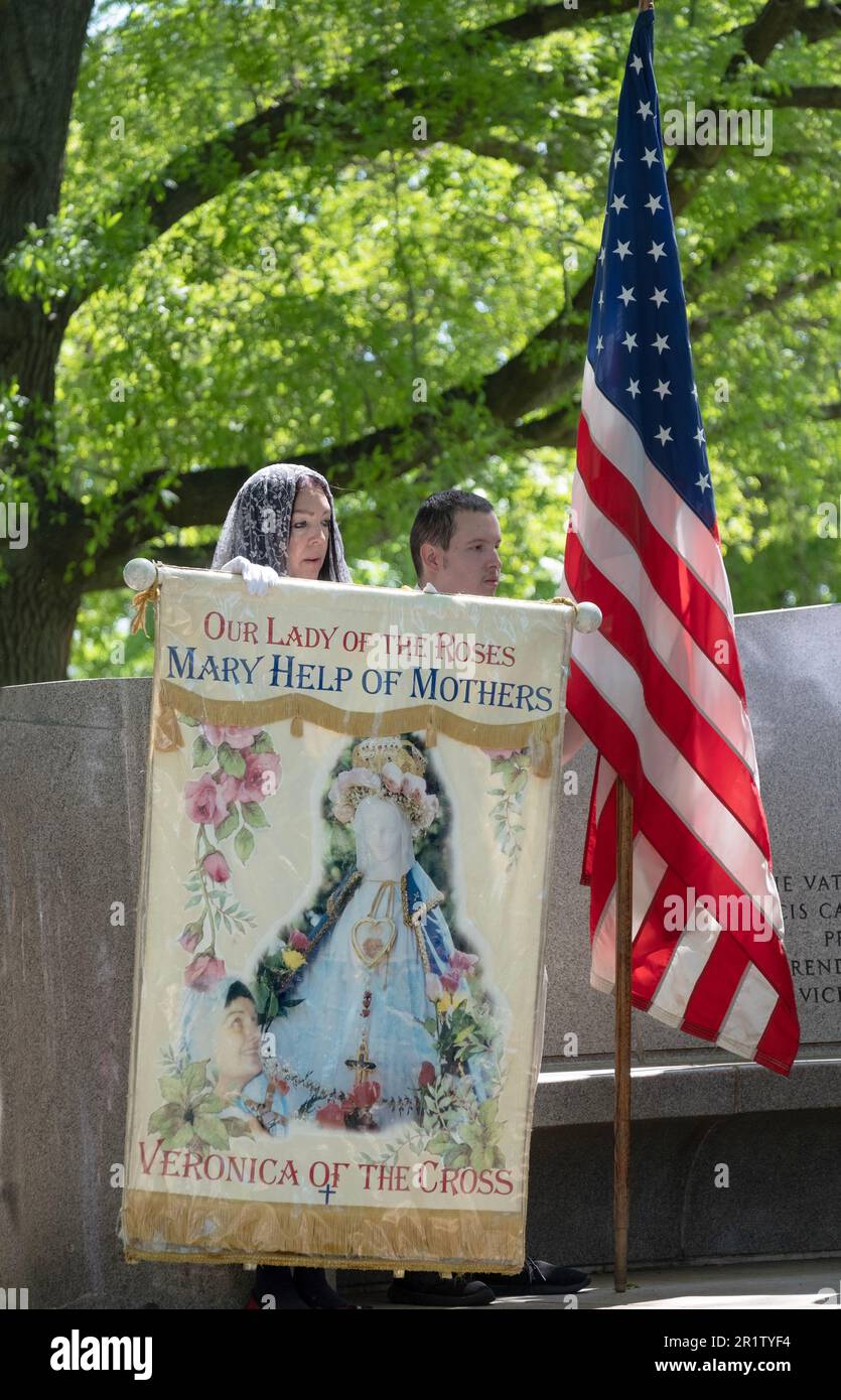 At the May Crowning ceremony, a devout Roman Catholic woman holds a ...