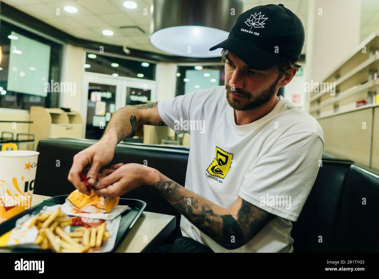 guy eating fast food at night. USA - May 2023. High quality photo Stock ...