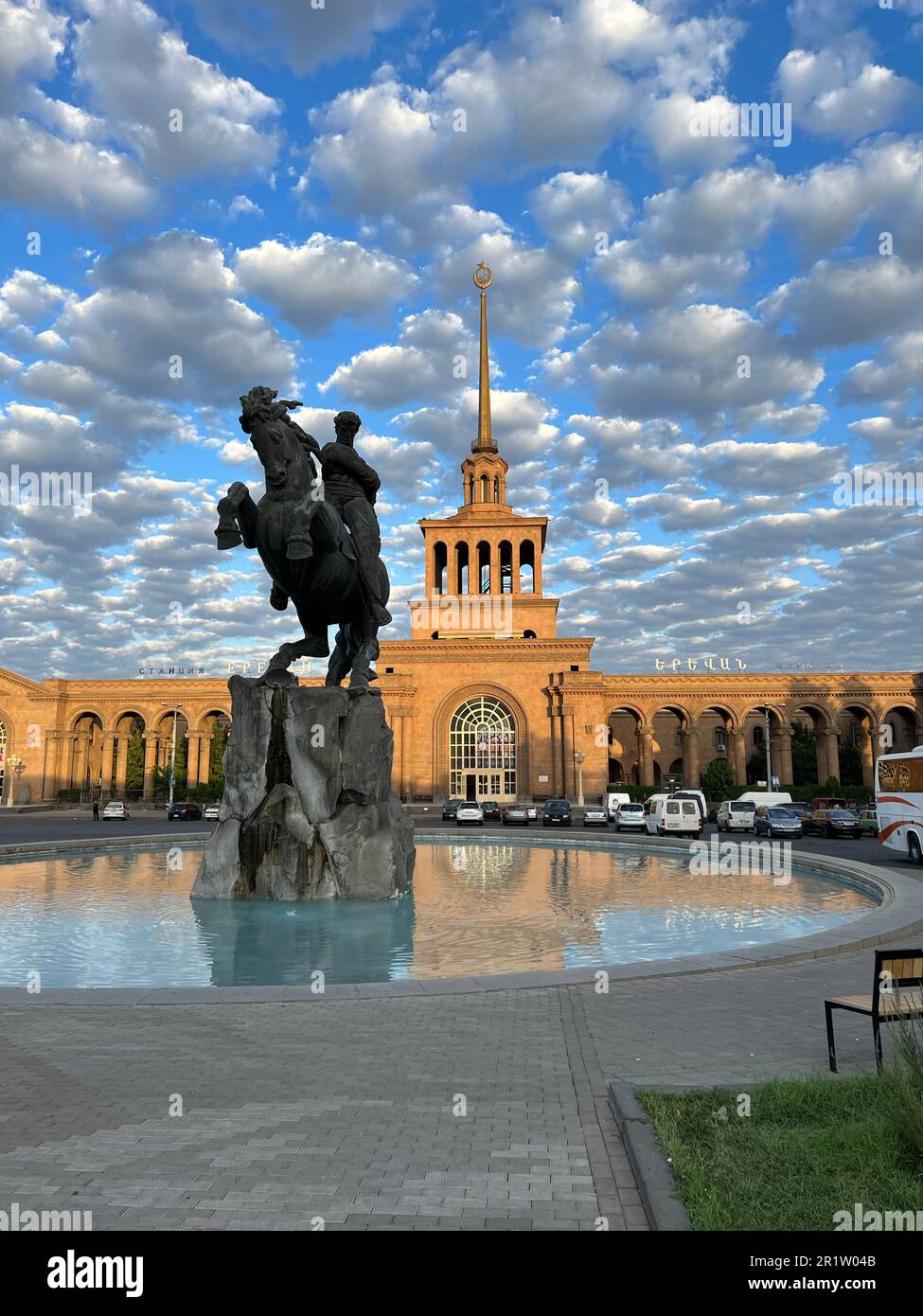 A bronze Sasuntsi David statue in front of a large building subway ...