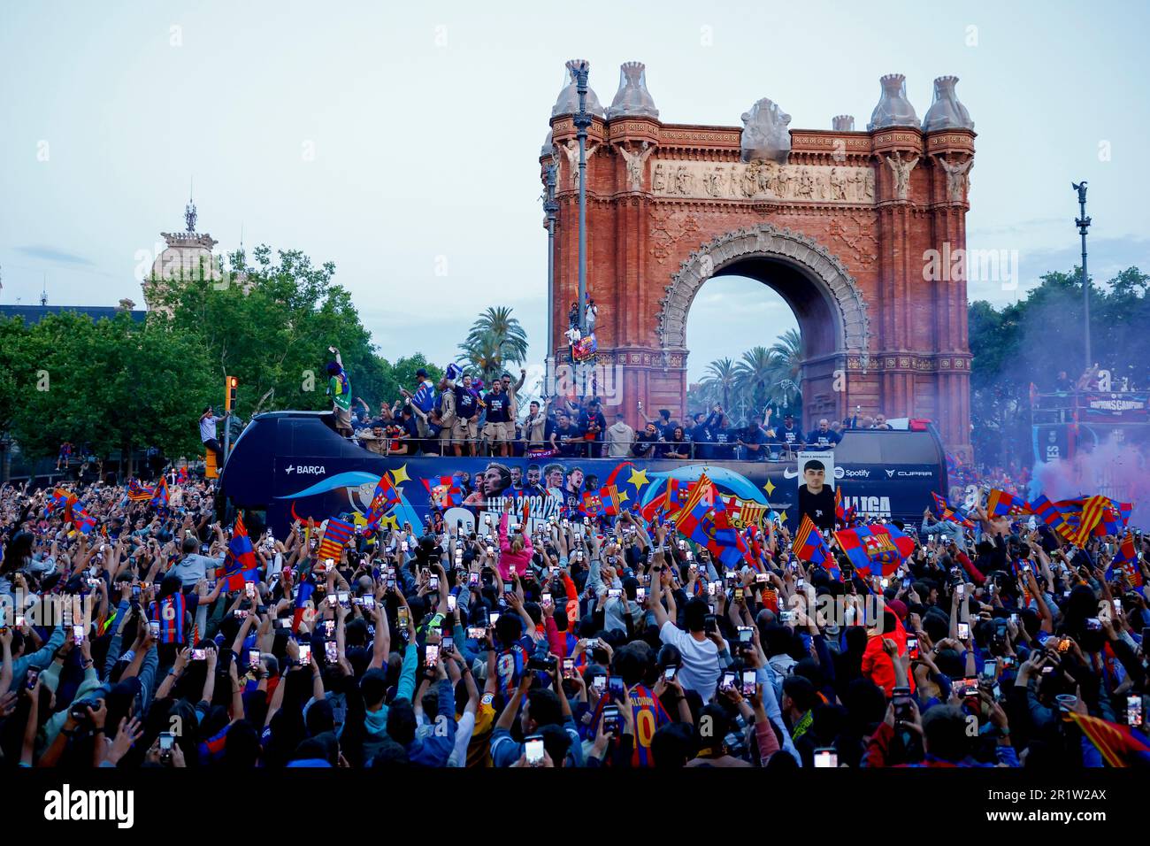Barcelona men's team players celebrate from a bus during a parade to ...