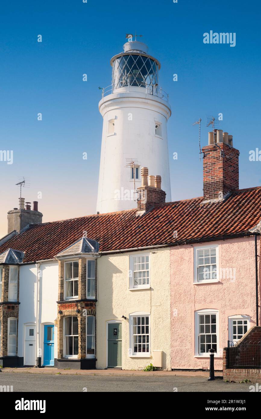 The lighthouse behind and towering above houses in the seaside town of ...