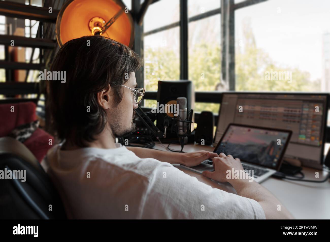 Positive musician working in recording studio Stock Photo - Alamy