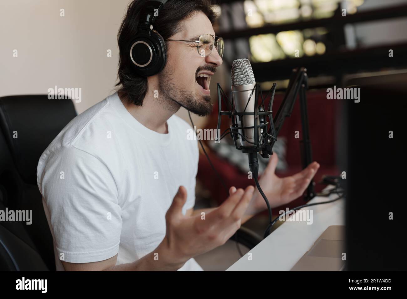 Man singing in recording studio Stock Photo - Alamy