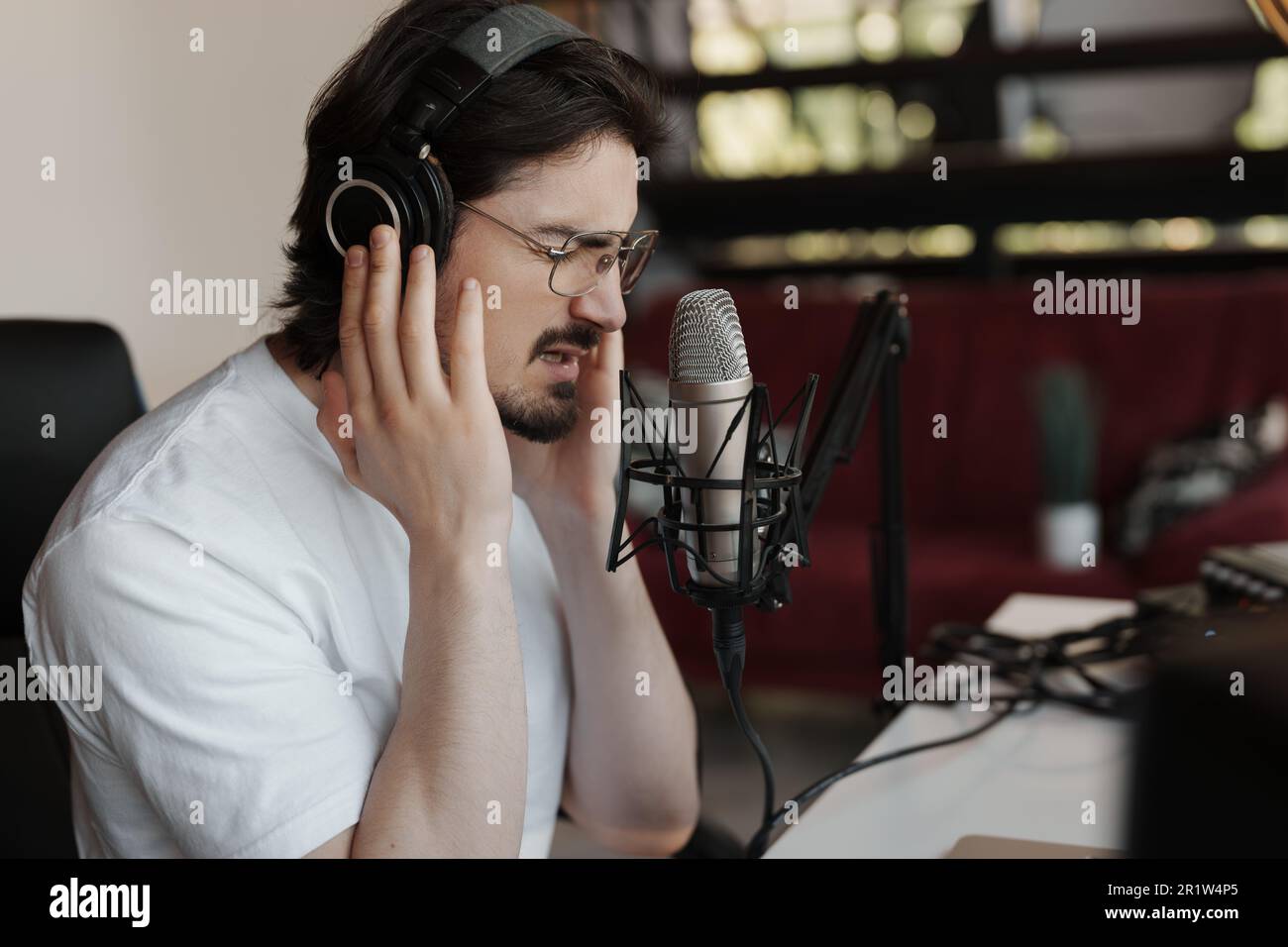 Man singing in recording studio Stock Photo - Alamy