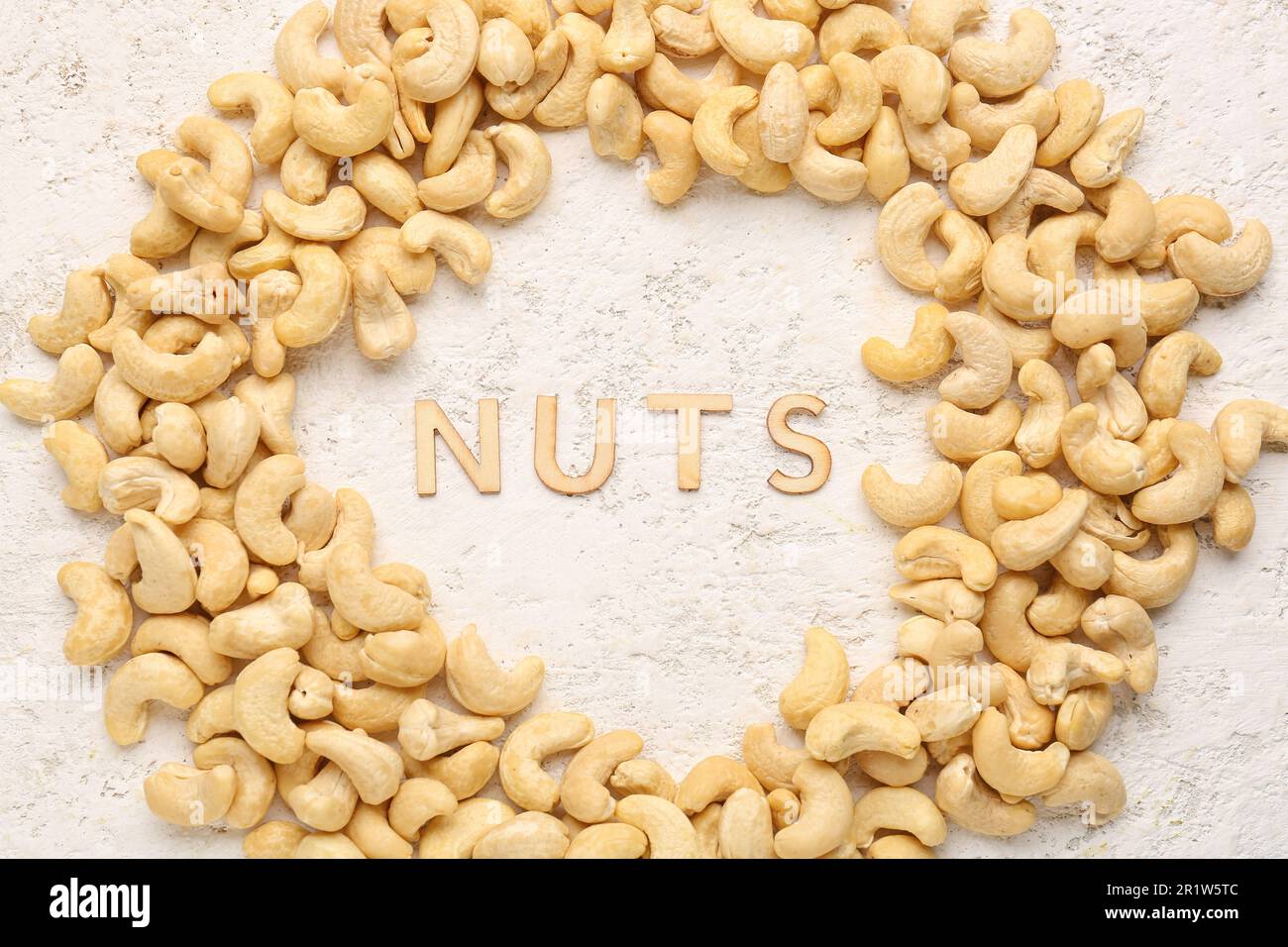 Frame made of cashew and word NUTS on light background Stock Photo - Alamy