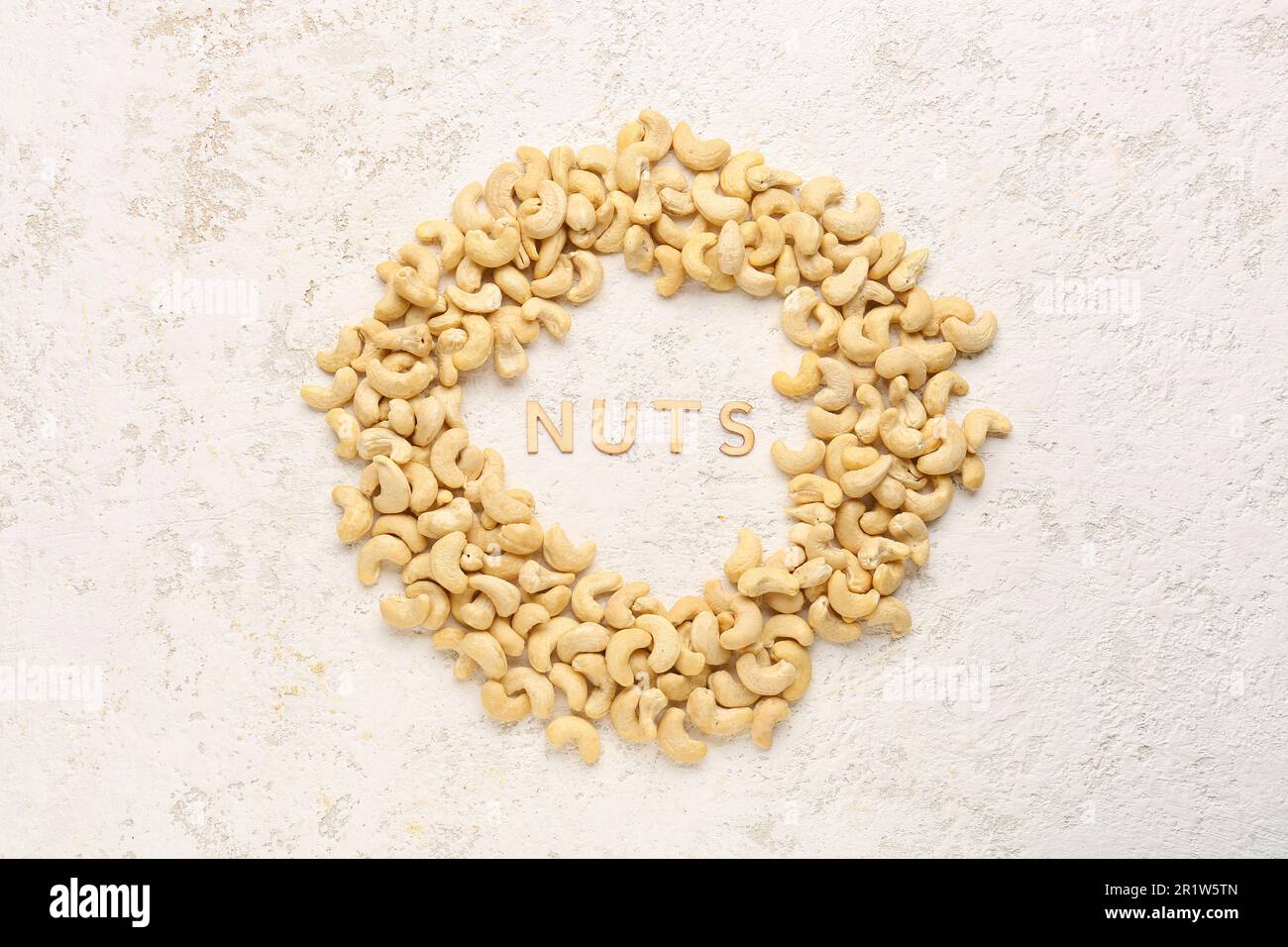 Frame made of cashew and word NUTS on light background Stock Photo - Alamy