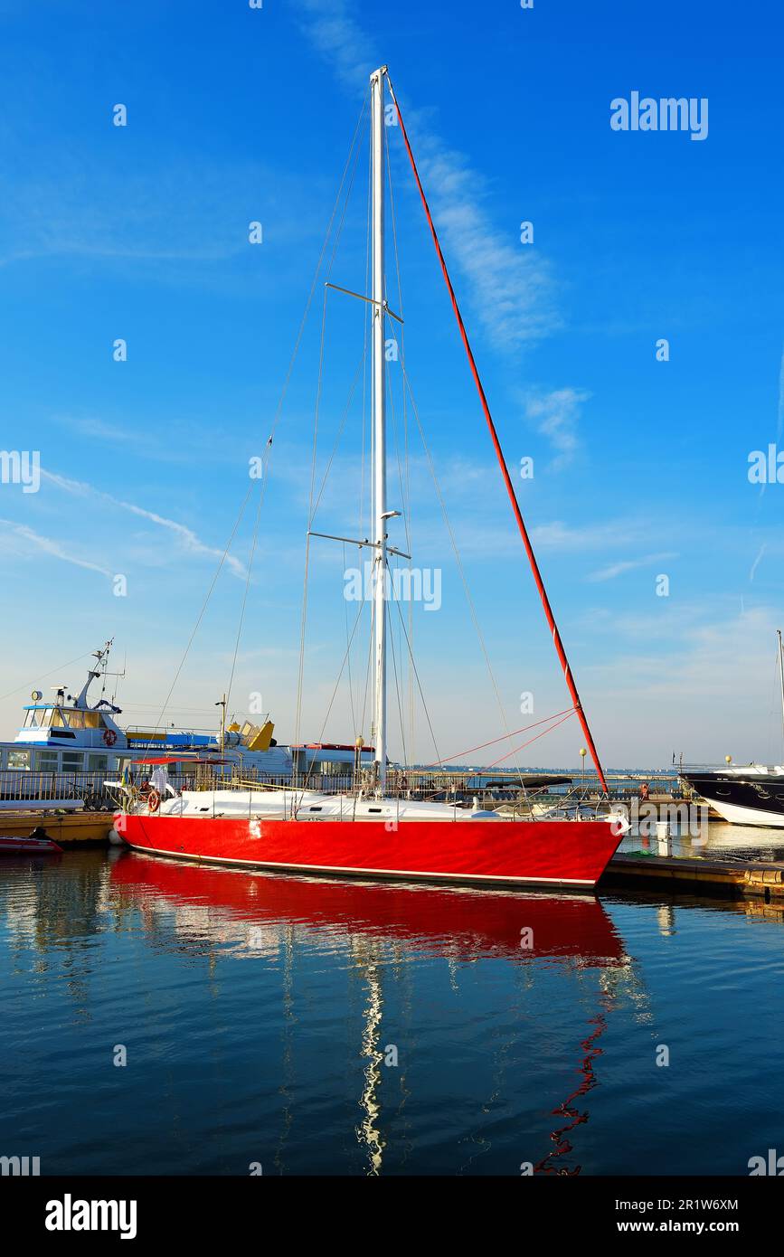 sailing yacht with a flat sail is docked Stock Photo - Alamy