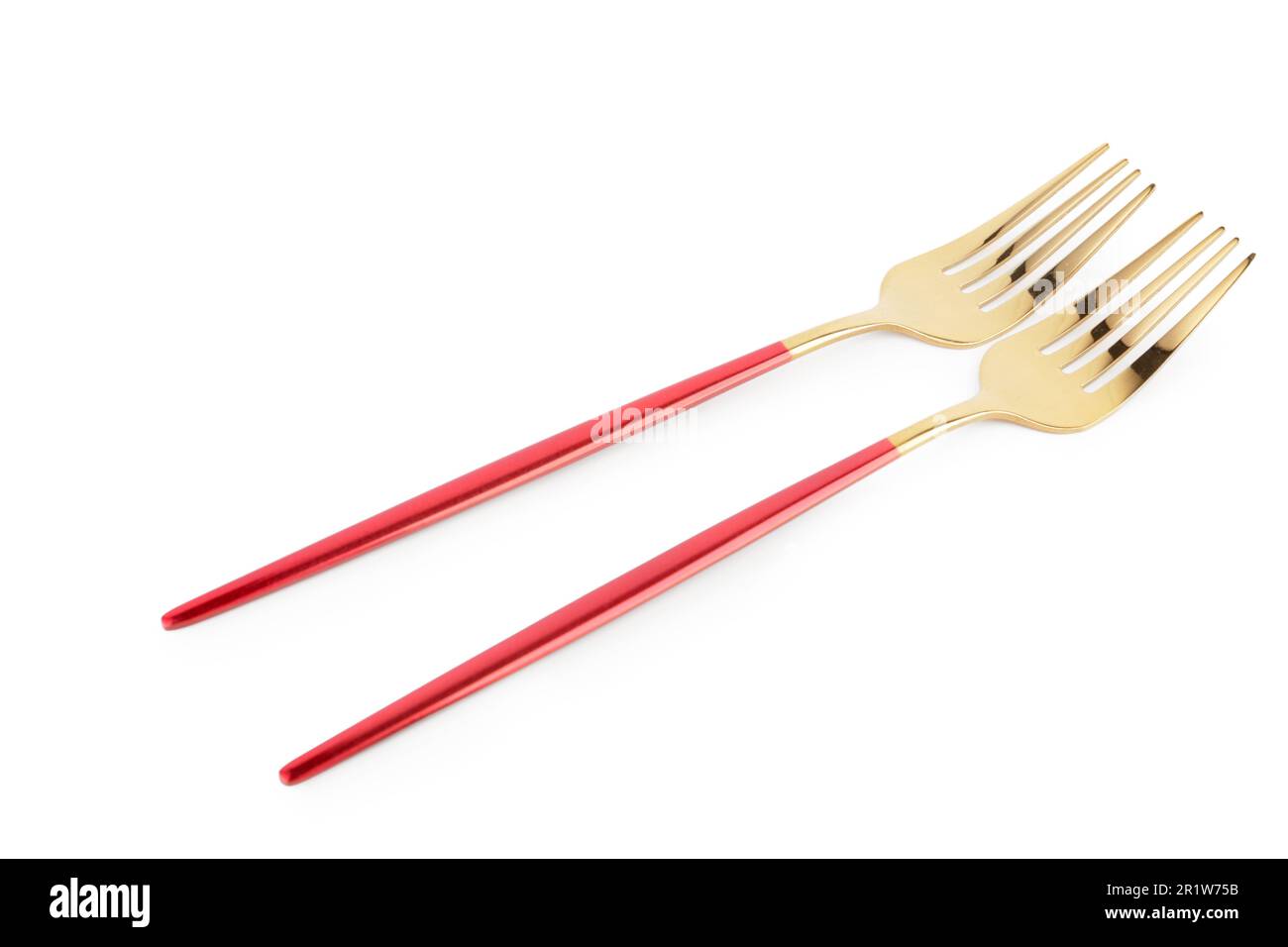 Golden forks with red handles on white background Stock Photo - Alamy