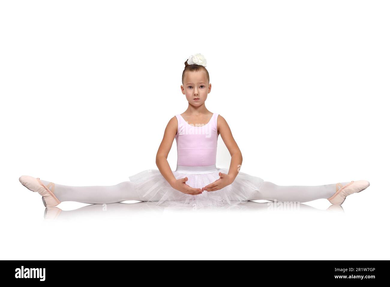 Little ballerina sitting on floor isolated on white background Stock ...