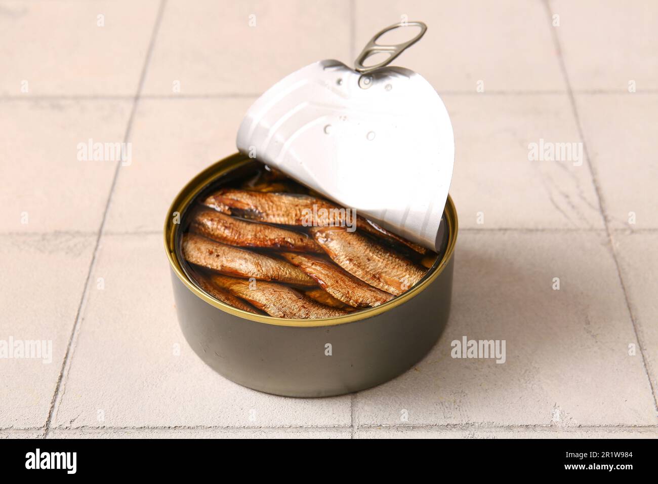 Canned smoked sprats on white tile background Stock Photo - Alamy